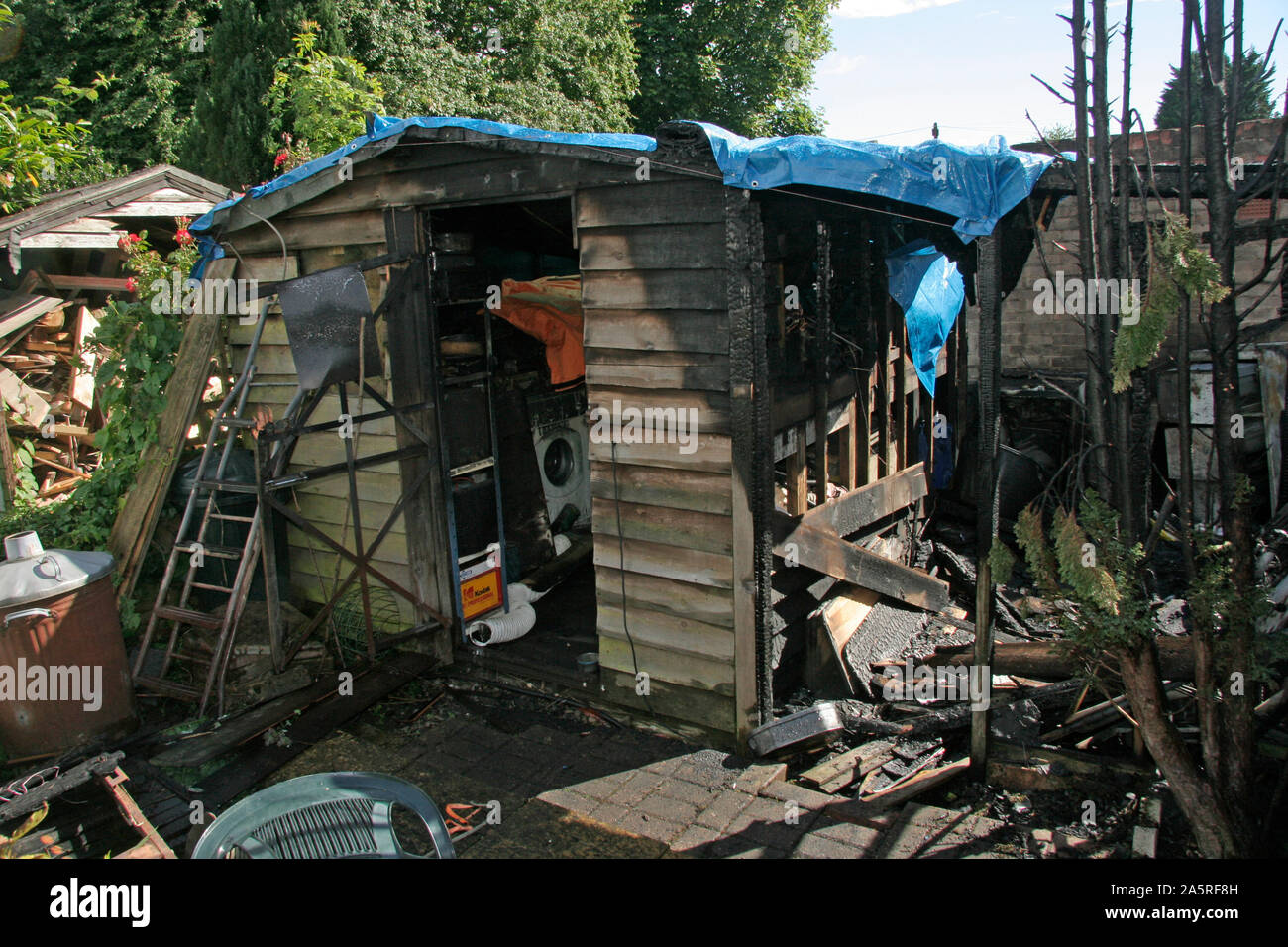 A Garden Shed fire caused by a faulty Refridgerator. Covered to protect ...