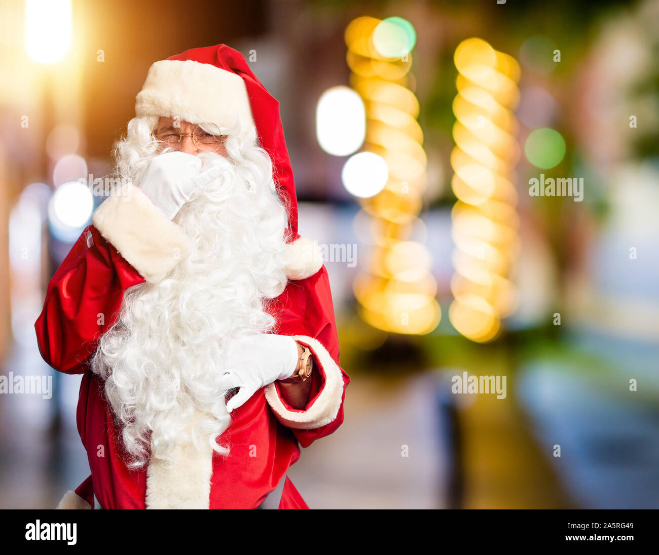 Middle age handsome man wearing Santa Claus costume and beard standing ...