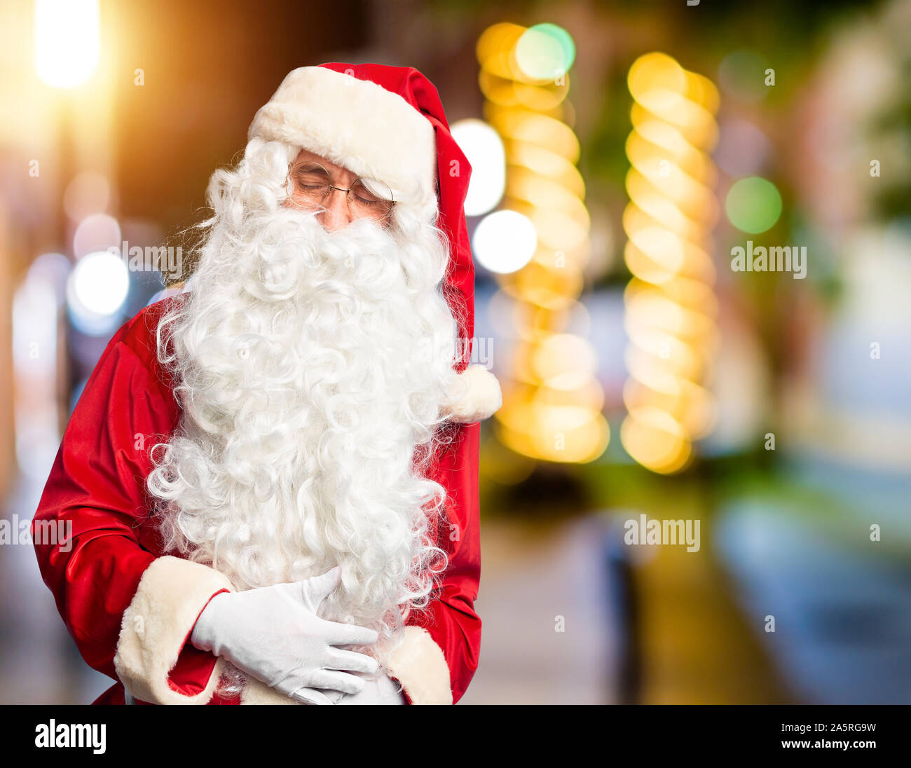 Middle age handsome man wearing Santa Claus costume and beard standing ...