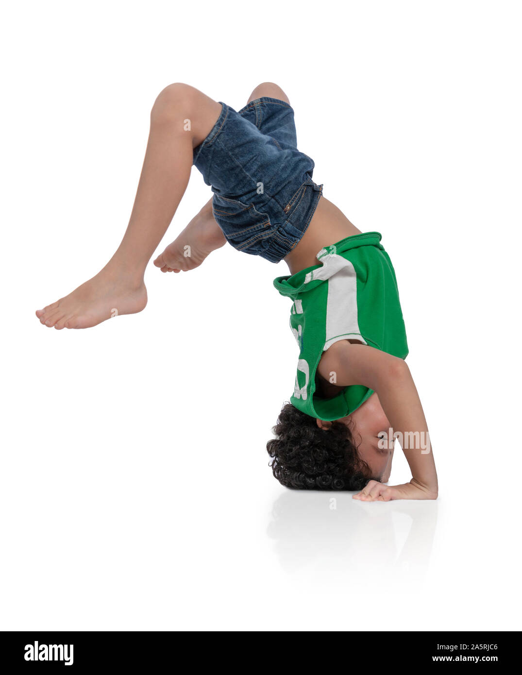 Active Joyful Boy Balancing on His Hands and Head Stock Photo - Alamy