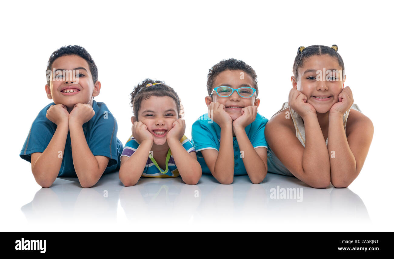 A Group of Happy Children Laying on White Floor Posing for Photo Stock ...