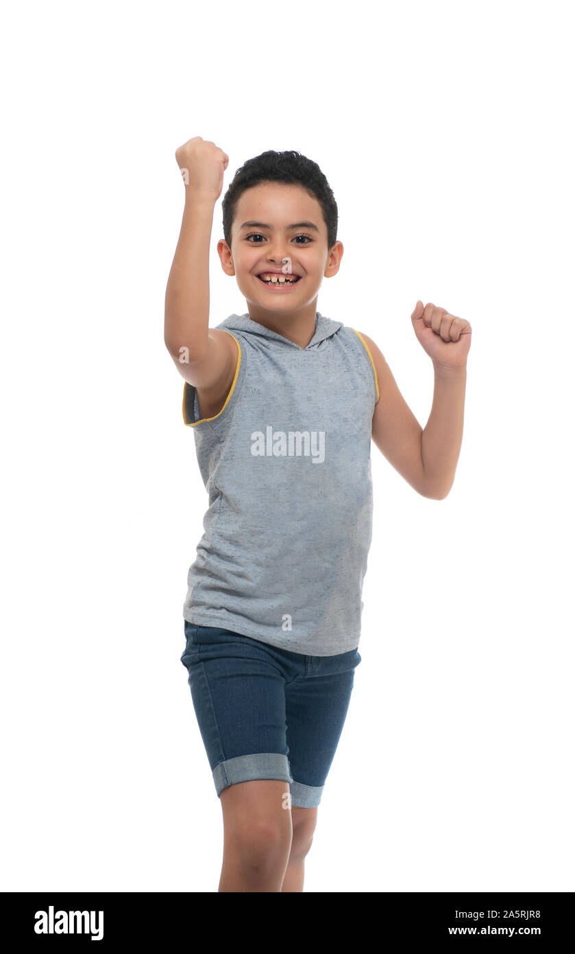 A Happy Young Winner Boy Celebrating His Success, Hands Up Over White ...