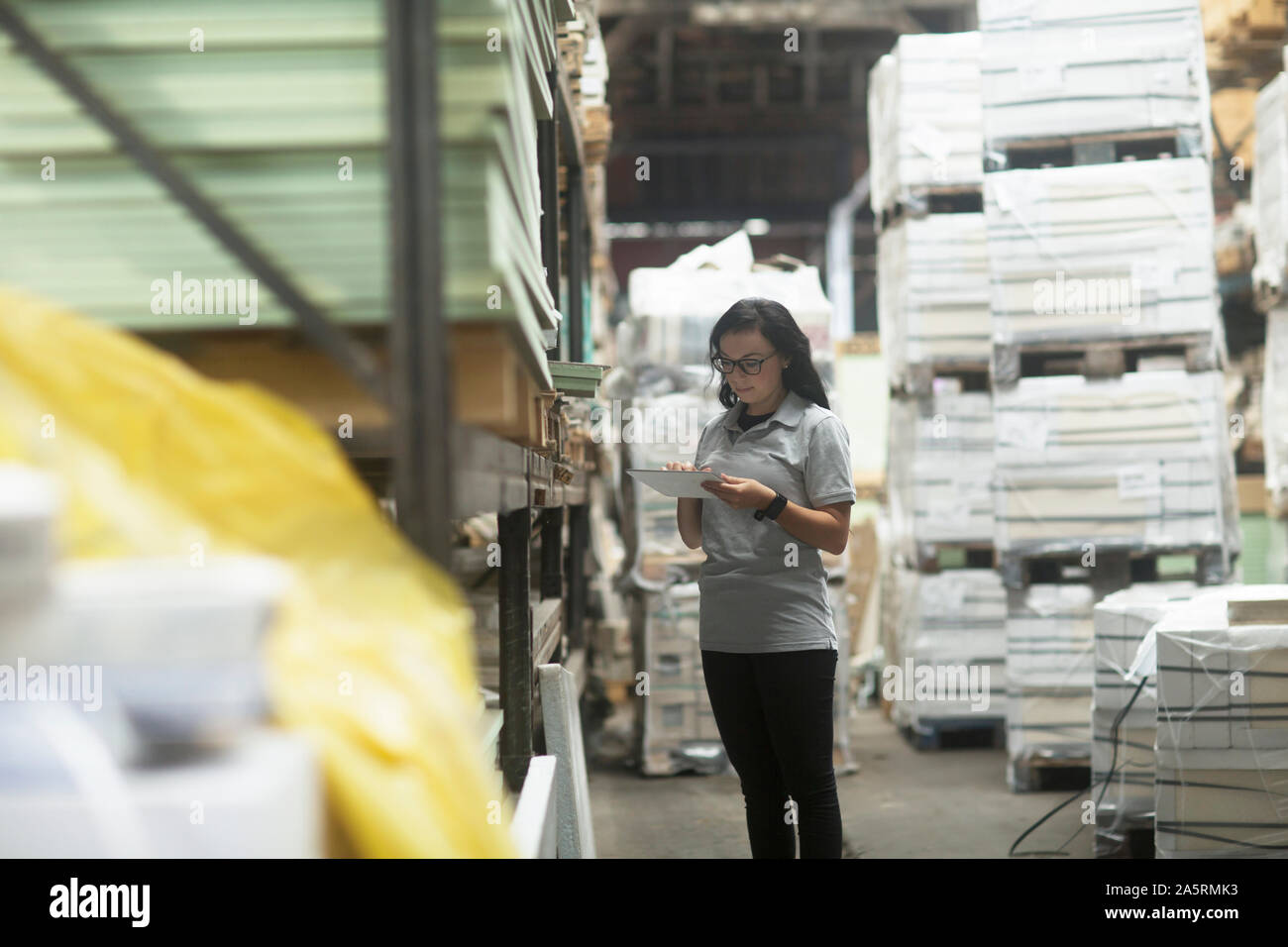 storekeeper female in a warehouse Stock Photo - Alamy