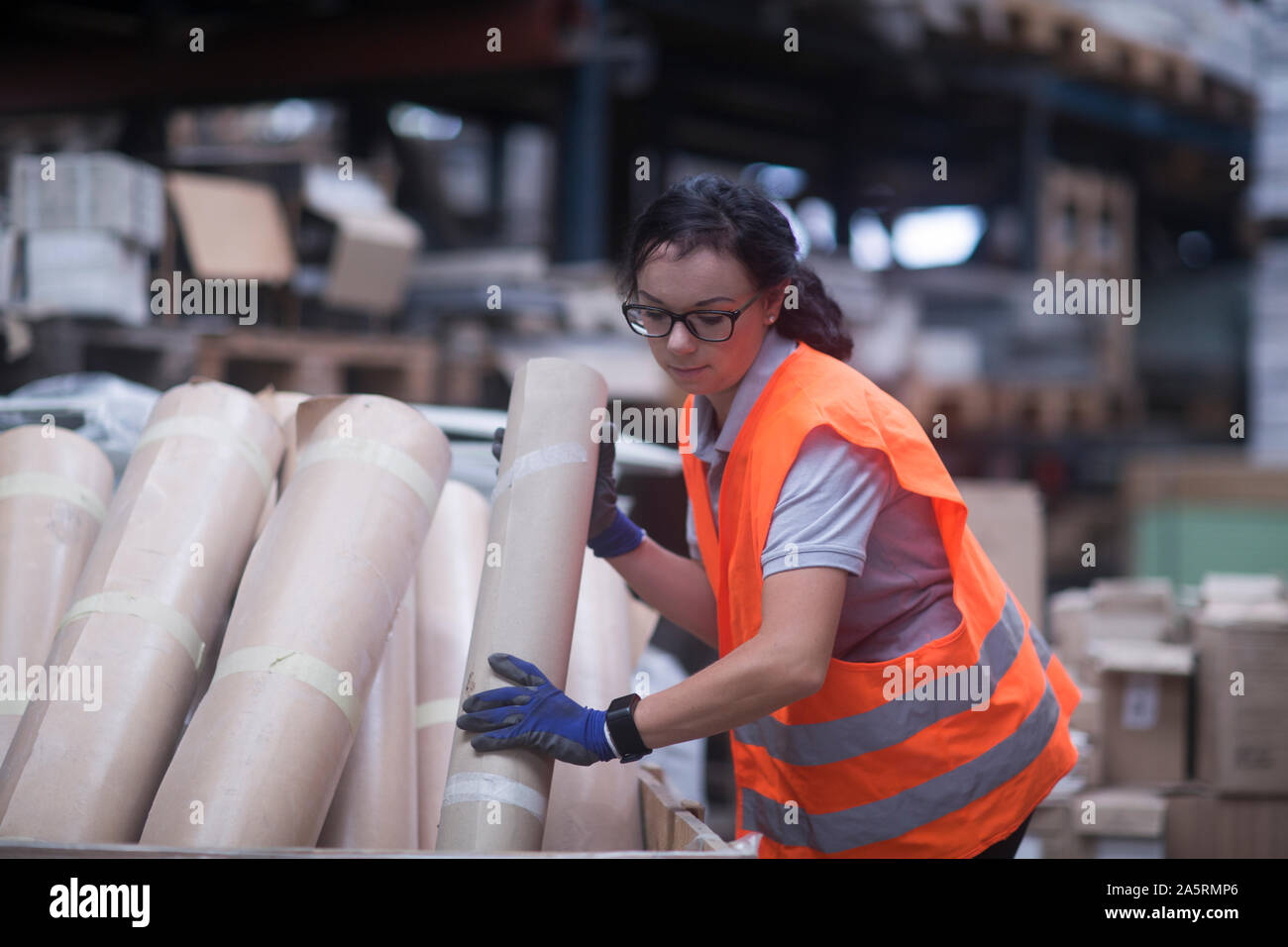 storekeeper female in a warehouse with propducts Stock Photo - Alamy