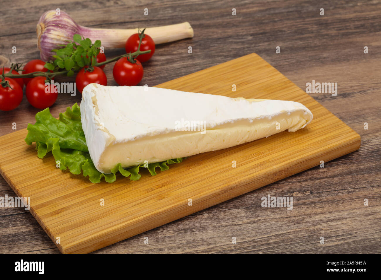 Brie cheese triangle served salad leaves Stock Photo - Alamy