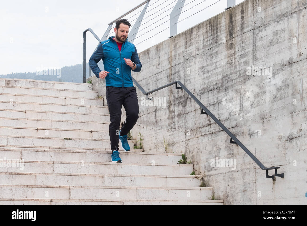 Active guy training on modern city stairs Stock Photo - Alamy