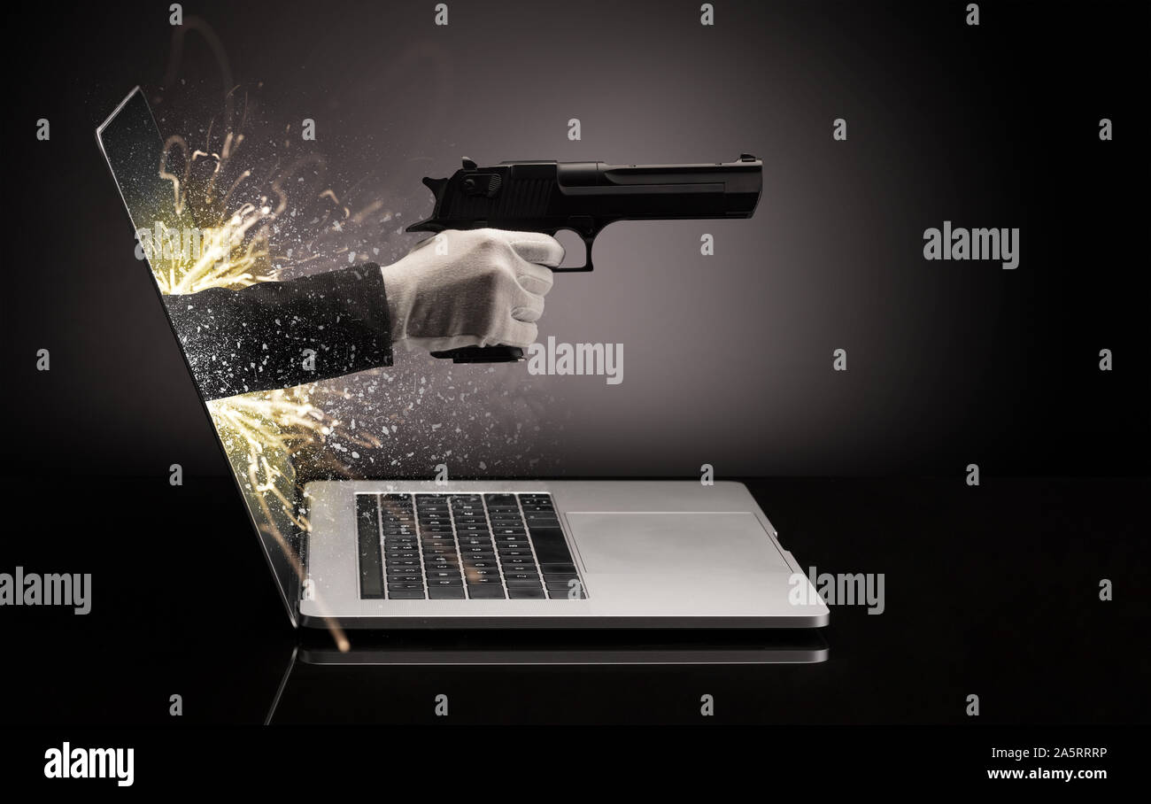 Hand with gun coming out of a laptop with sparkling effects Stock Photo ...