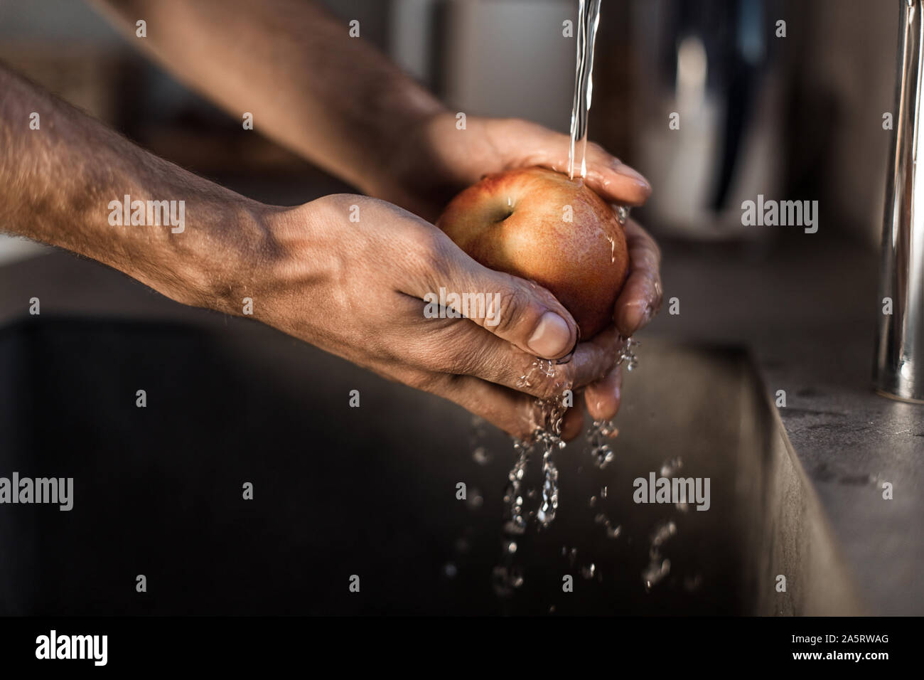 Red apple with a tap hi-res stock photography and images - Alamy