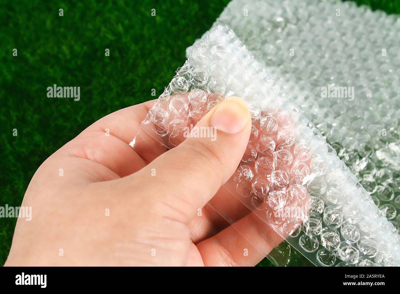The hand touches the bubble wrap. The concept of touch, tactility ...