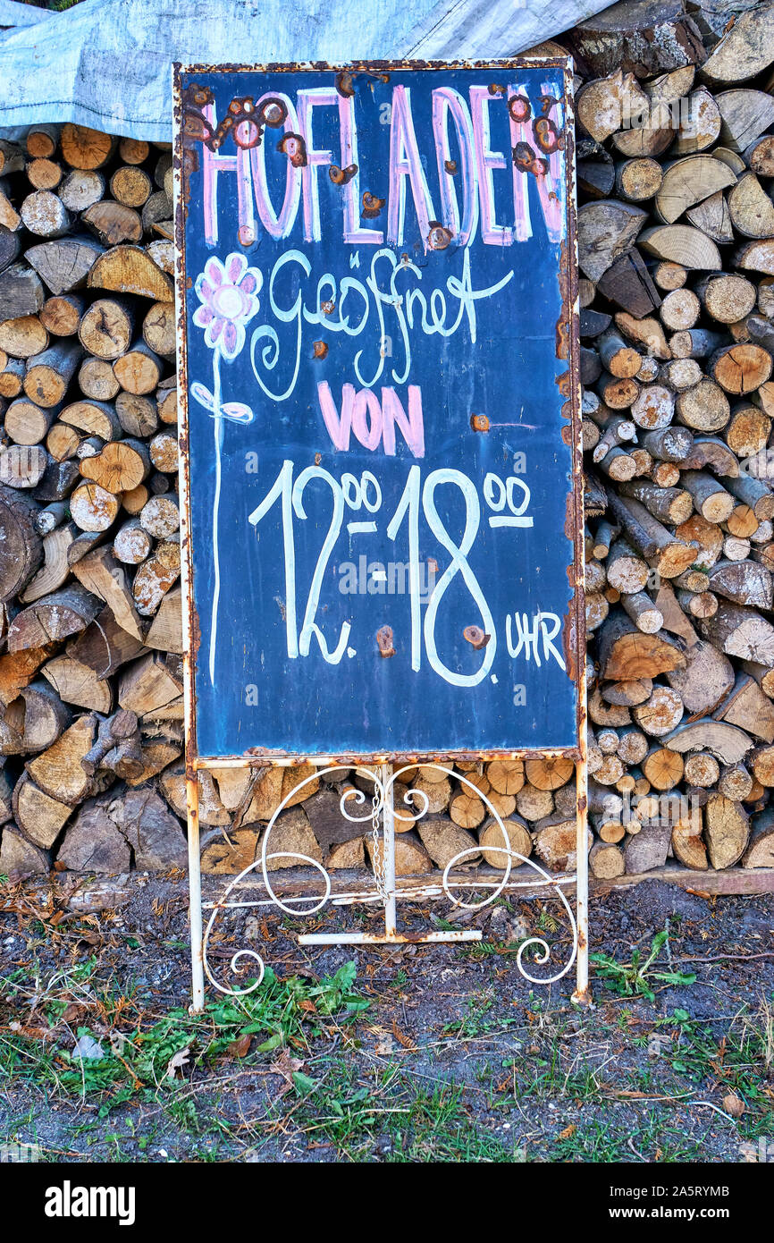 Old metal sign with the inscription farm shop opened. In German ...