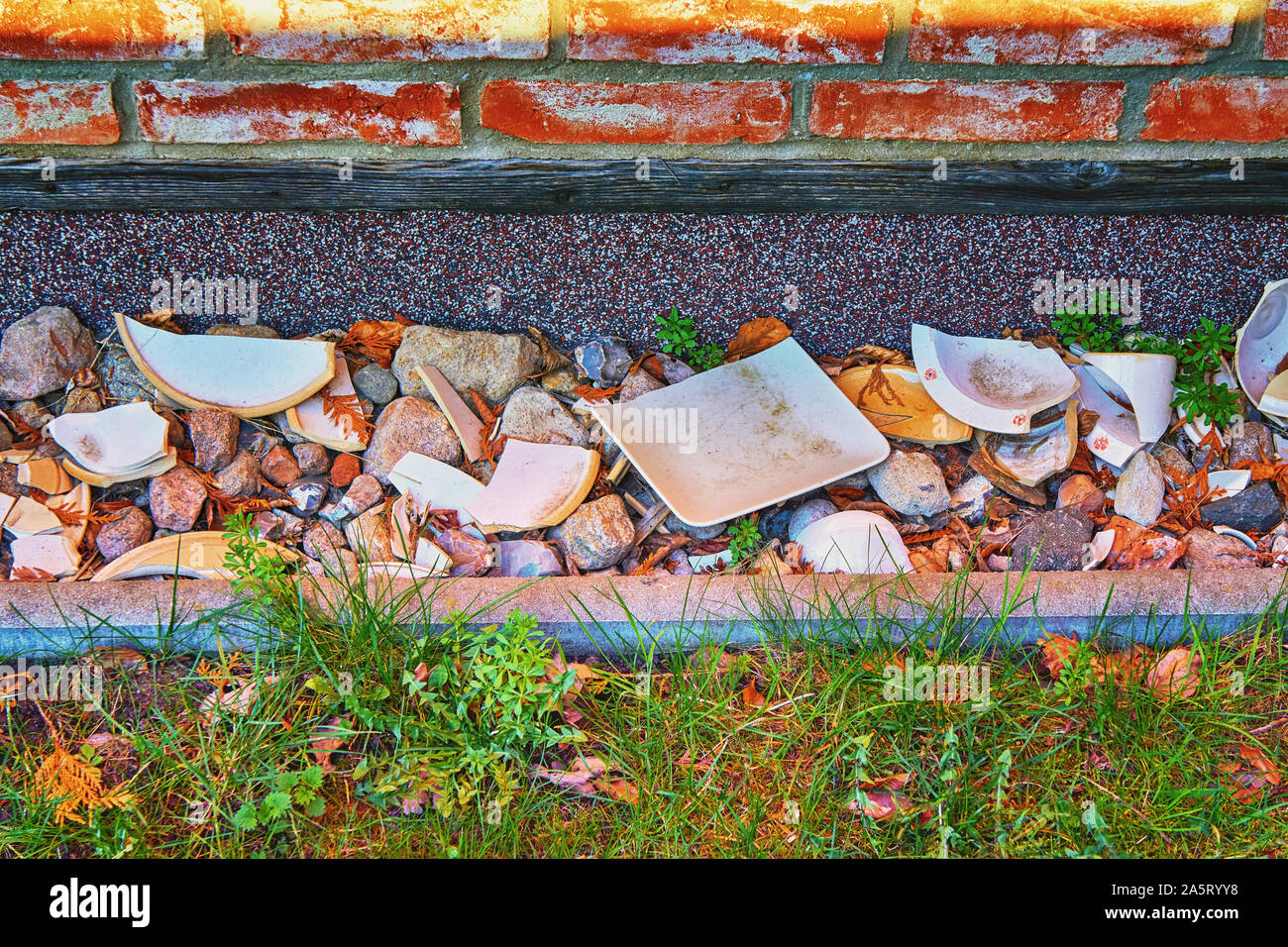 Decorative ceramic shards on a brick house wall Stock Photo - Alamy