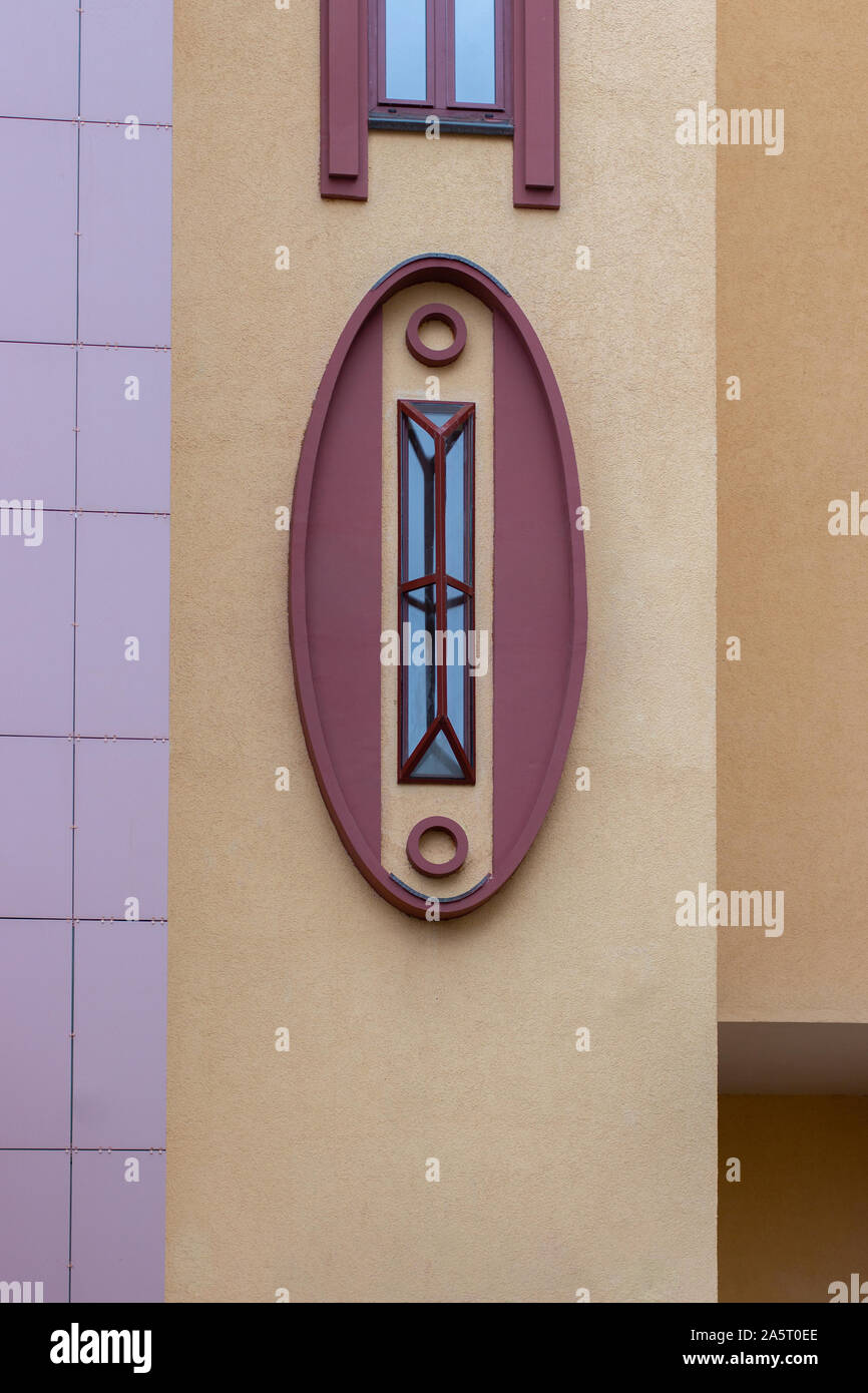 A beautiful oval window with an unusual design, the facade of a modern ...