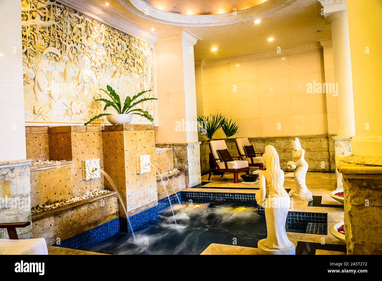 high class luxury spa with sculptures and fountains and lounge chairs ...