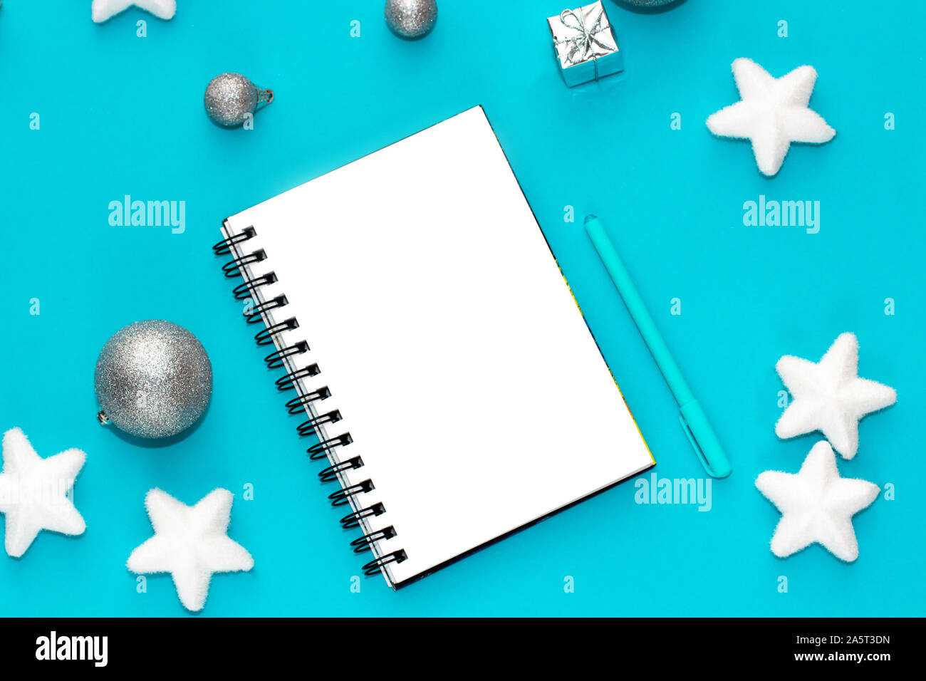 Notebook white mockup on mint green background. Top view with blank ...
