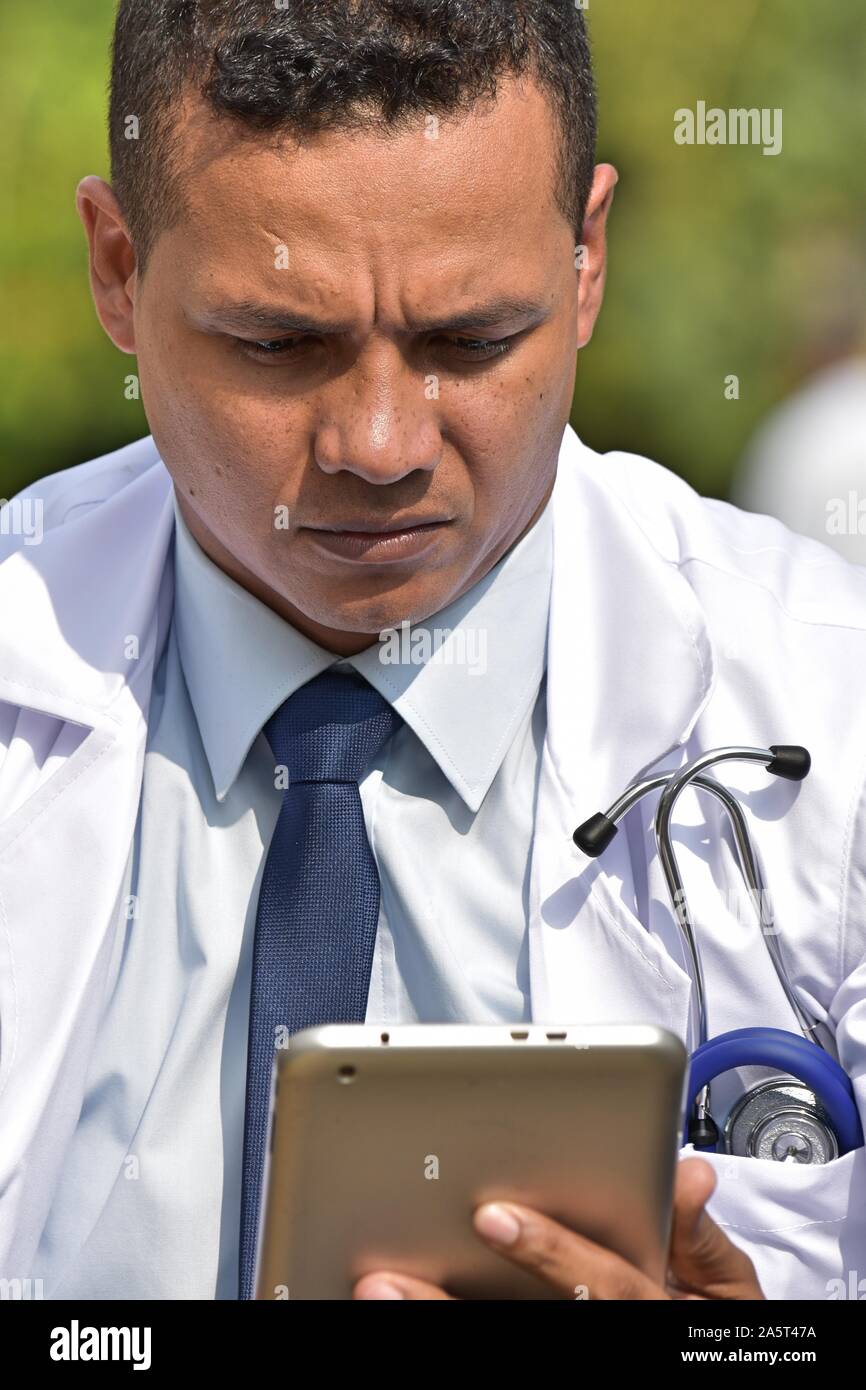 Serious Male Doctor Using Tablet Stock Photo - Alamy Serious Male Doctor Using Tablet Stock Photo - Alamy
