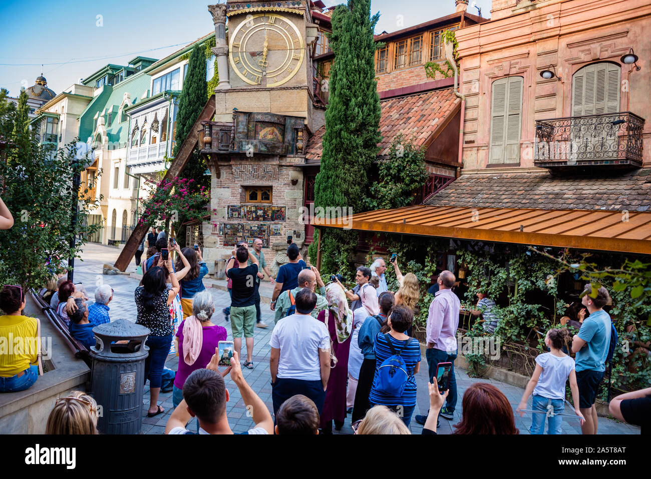 Tourist taking photos of Leaning Clock Tower of Tbilisi, Georgia Stock ...