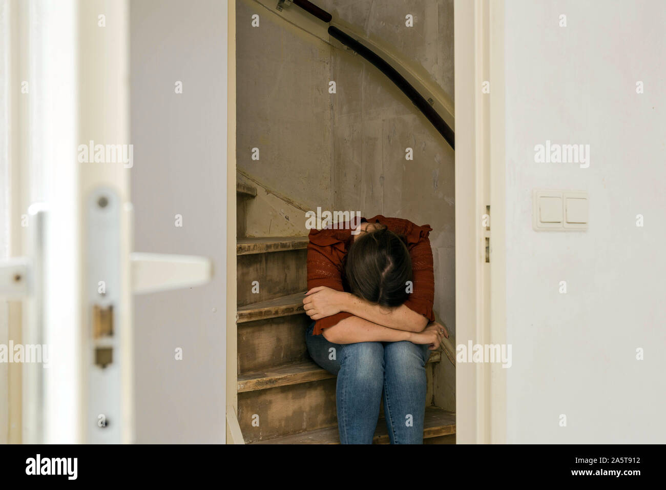 Sad girl sitting on stairs hi-res stock photography and images - Alamy