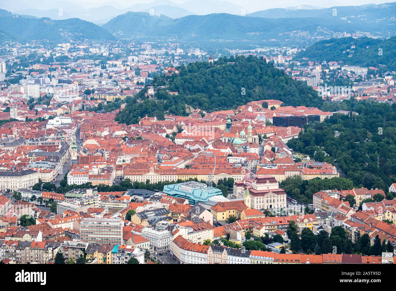 Aerial view of center city Graz from helicopter drone with hill ...