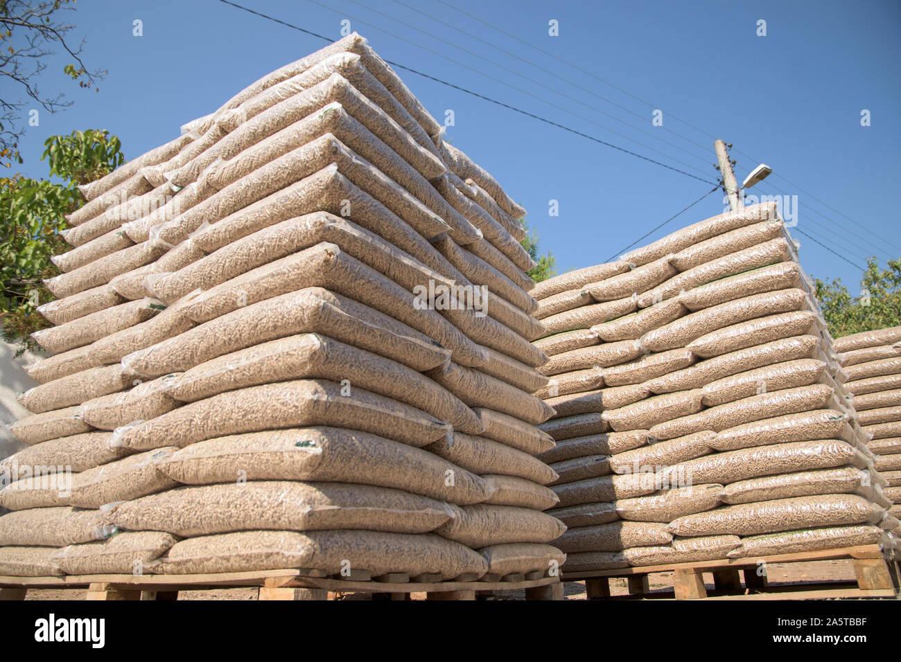 Big stacks of plastic bags full with wooden pellets Stock Photo - Alamy