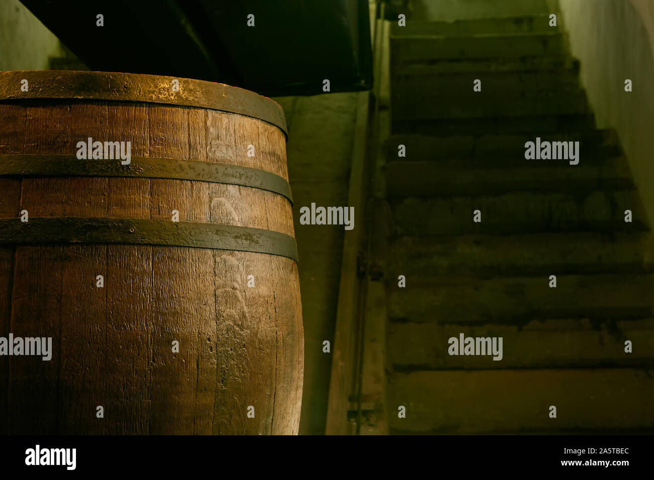 wooden barrel on a dark background, in a workshop, in an old room ...