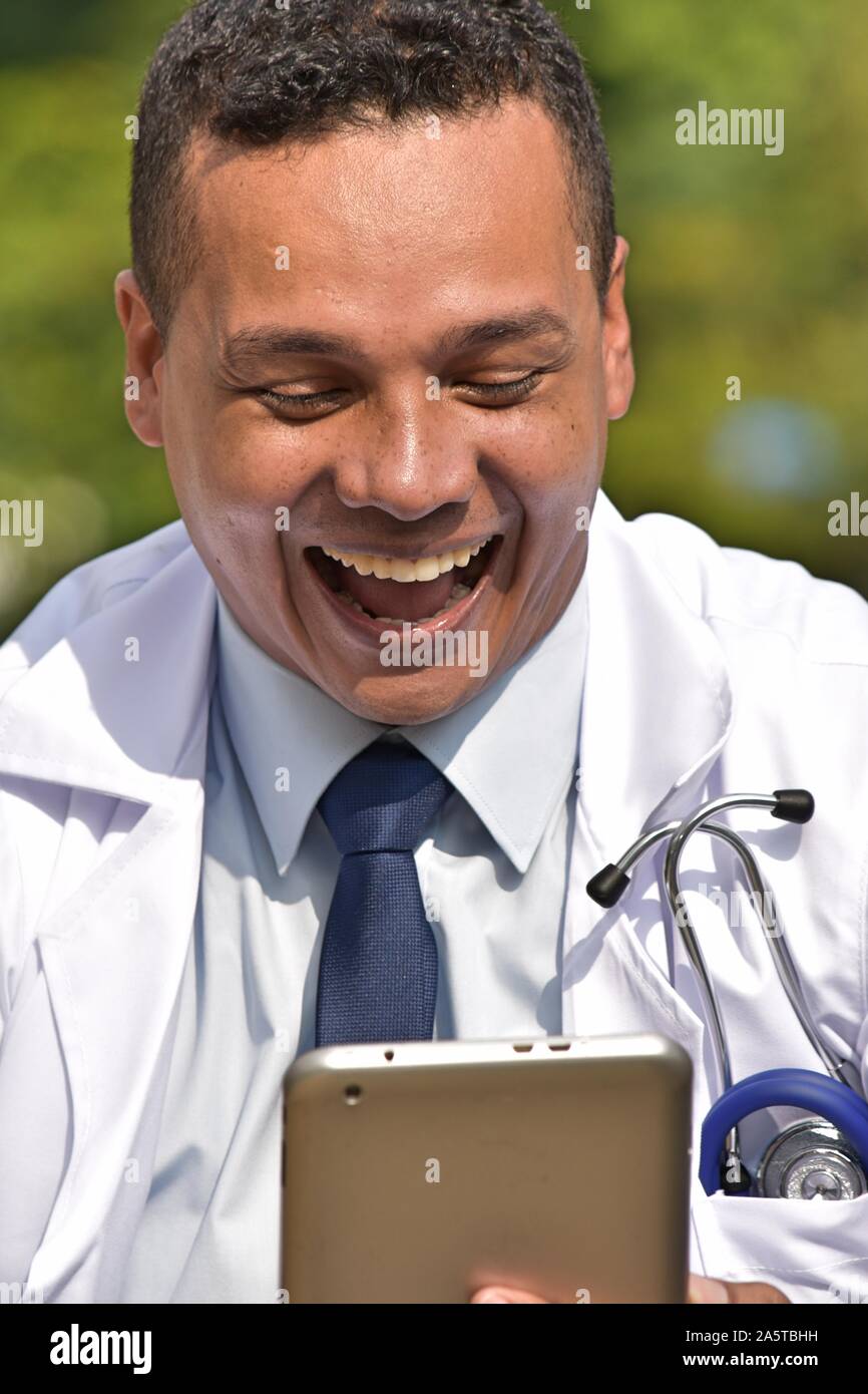 Laughing Male Doctor Using Tablet Stock Photo - Alamy