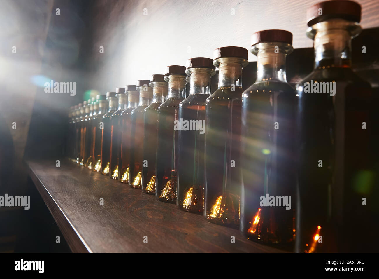 Colour scale gradation of whiskey and cognac infusion in bottles ...