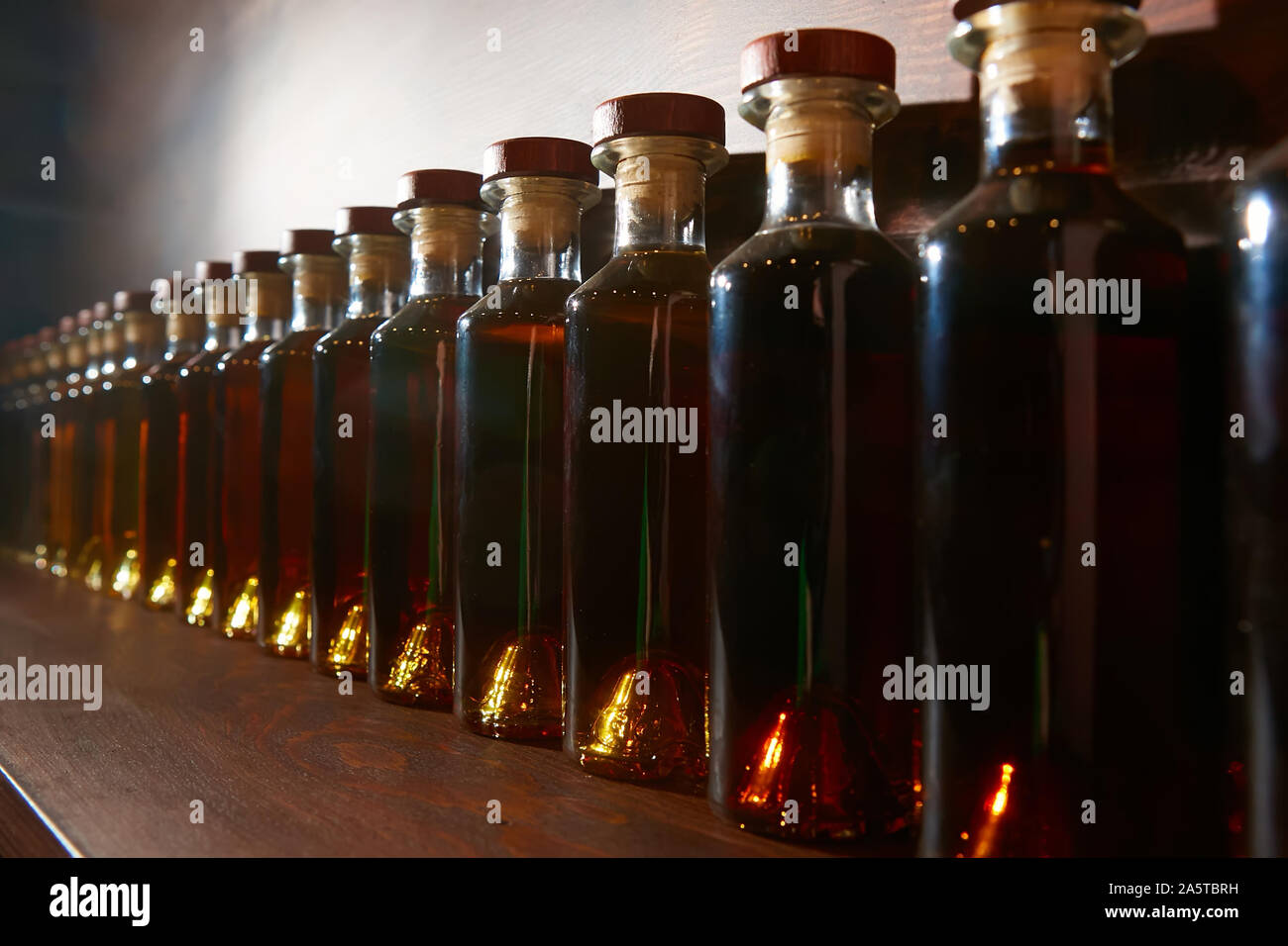 Colour scale gradation of whiskey and cognac infusion in bottles ...