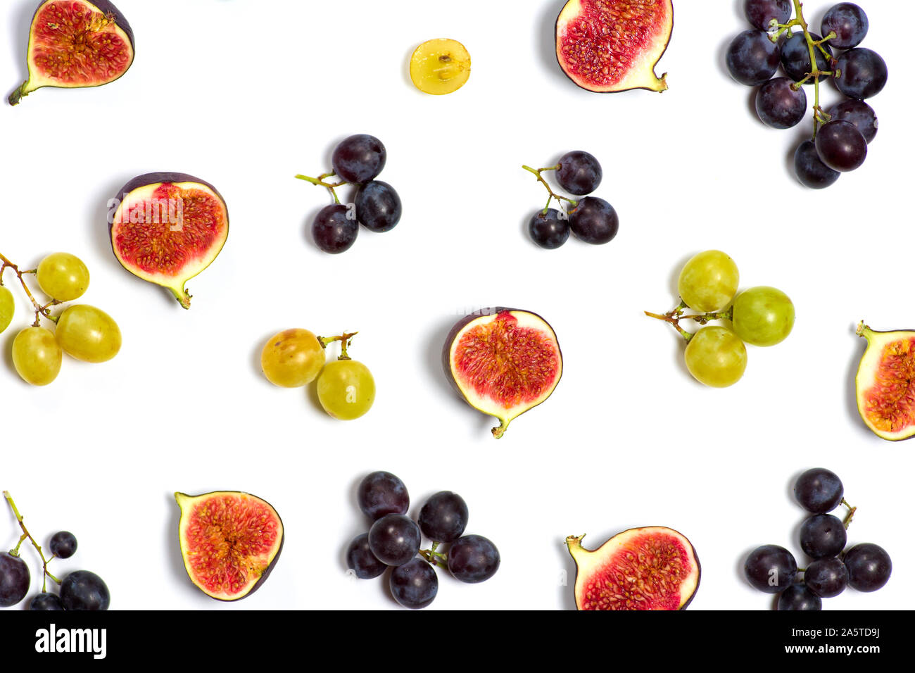 Figs and grapes on white background flat lay Stock Photo - Alamy