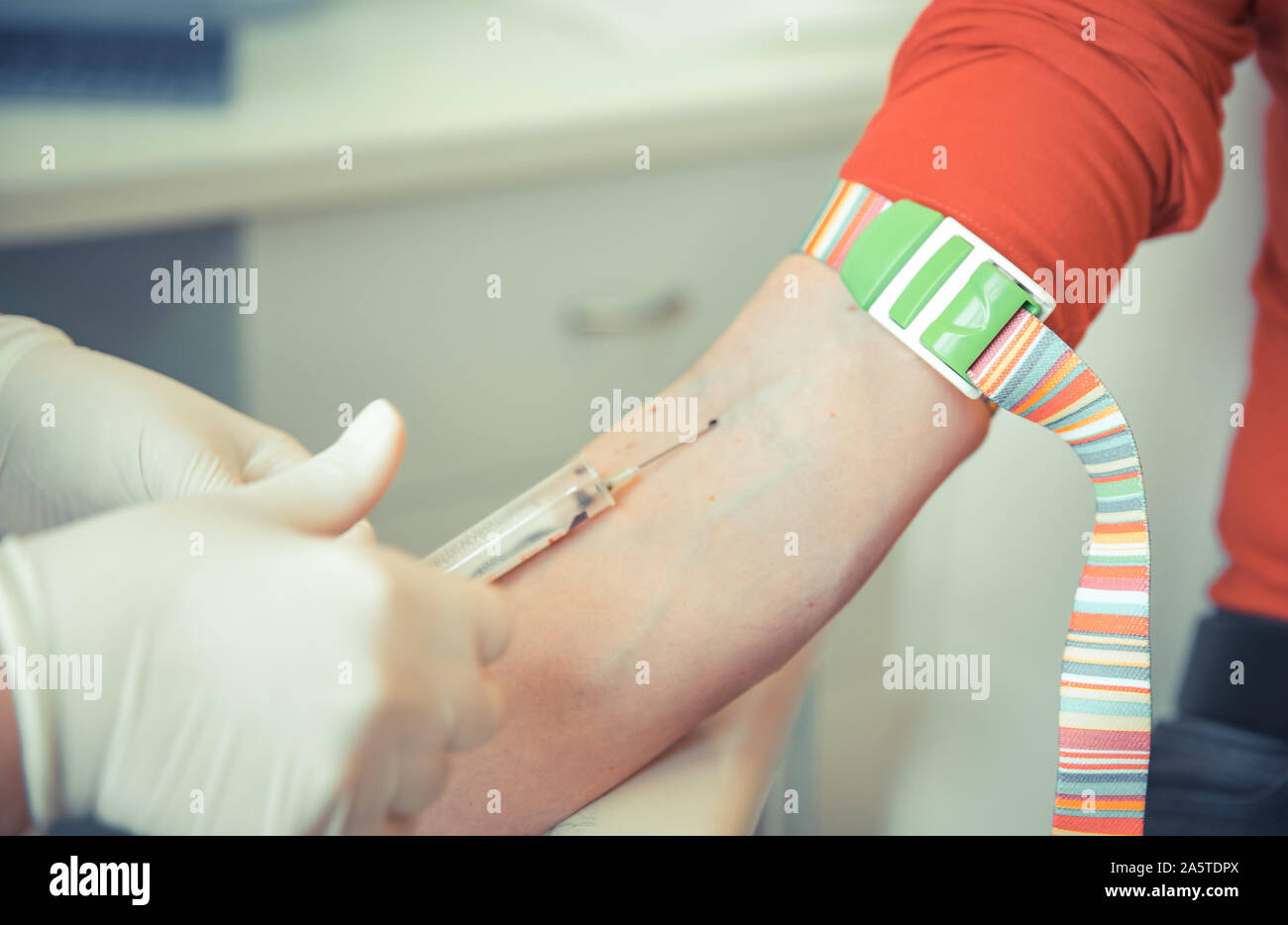 Young woman on the collection of blood in the hospital laboratory ...