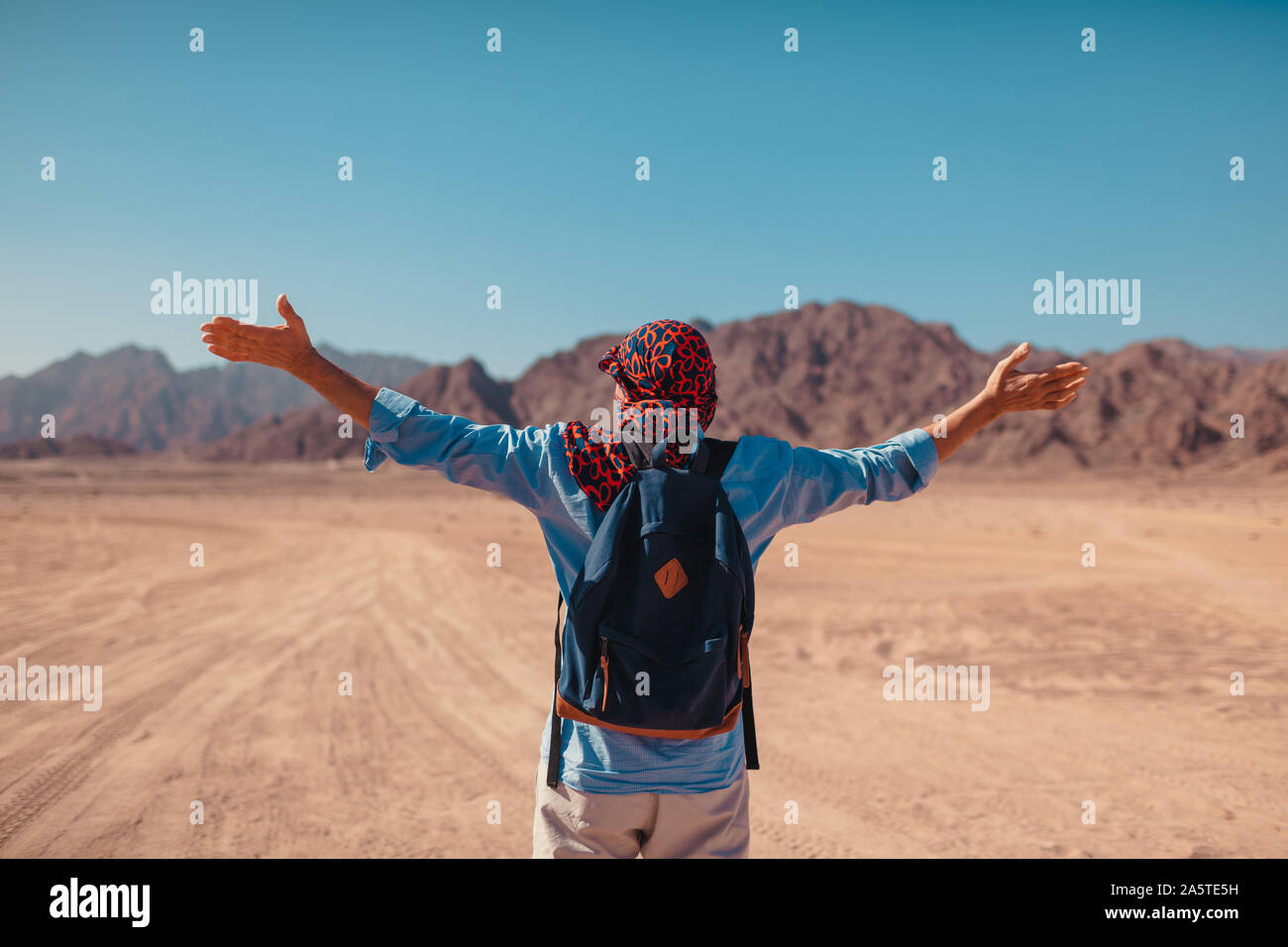 Tourist man with backpack raised arms feeling happy and free in Sinai ...