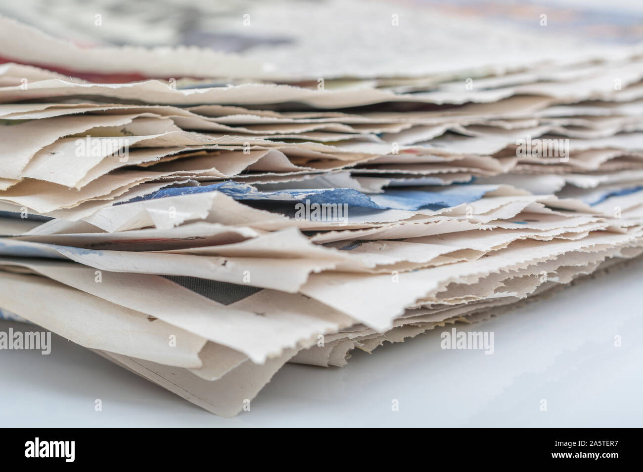 Old newspaper pages stacked. Traditional print media, front page news ...