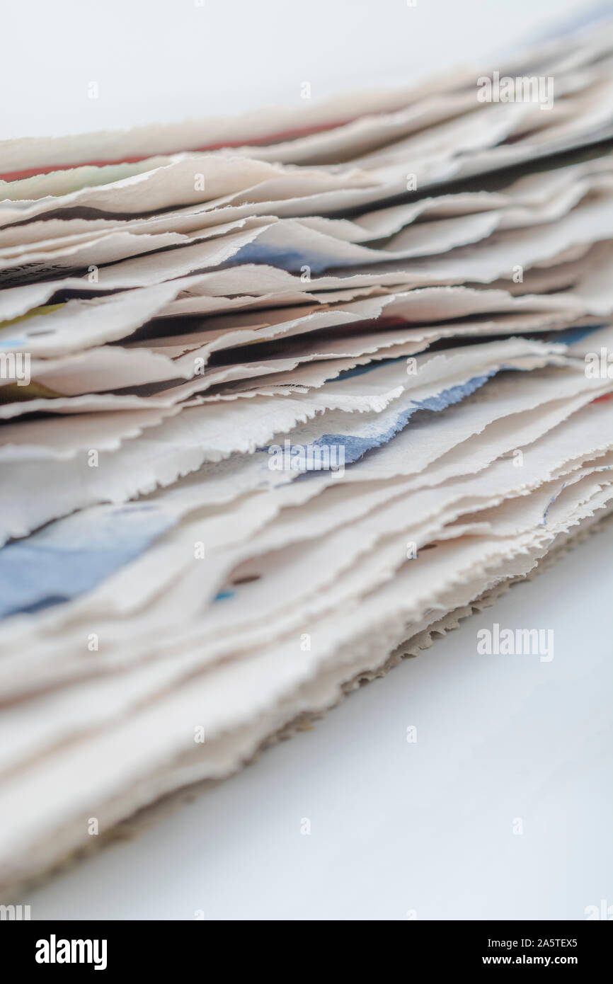 Old newspaper pages stacked. Traditional print media, front page news ...