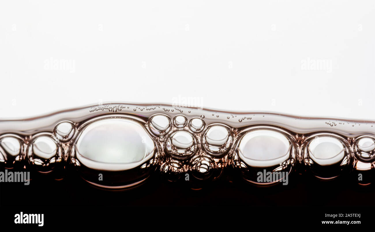 air bubbles in red wine on white background with copy space macro photo ...