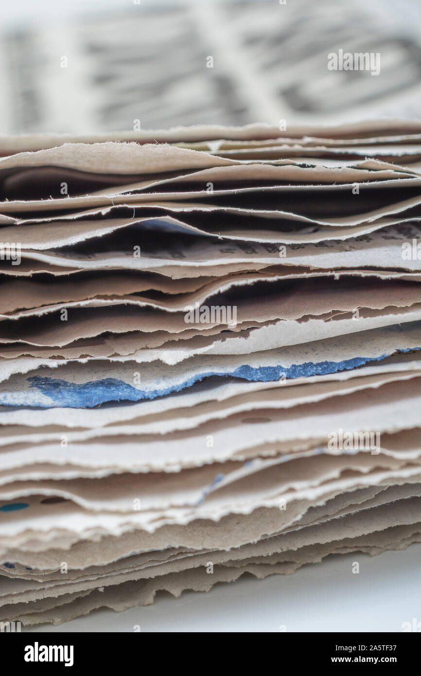 Old newspaper pages stacked. Traditional print media, front page news ...