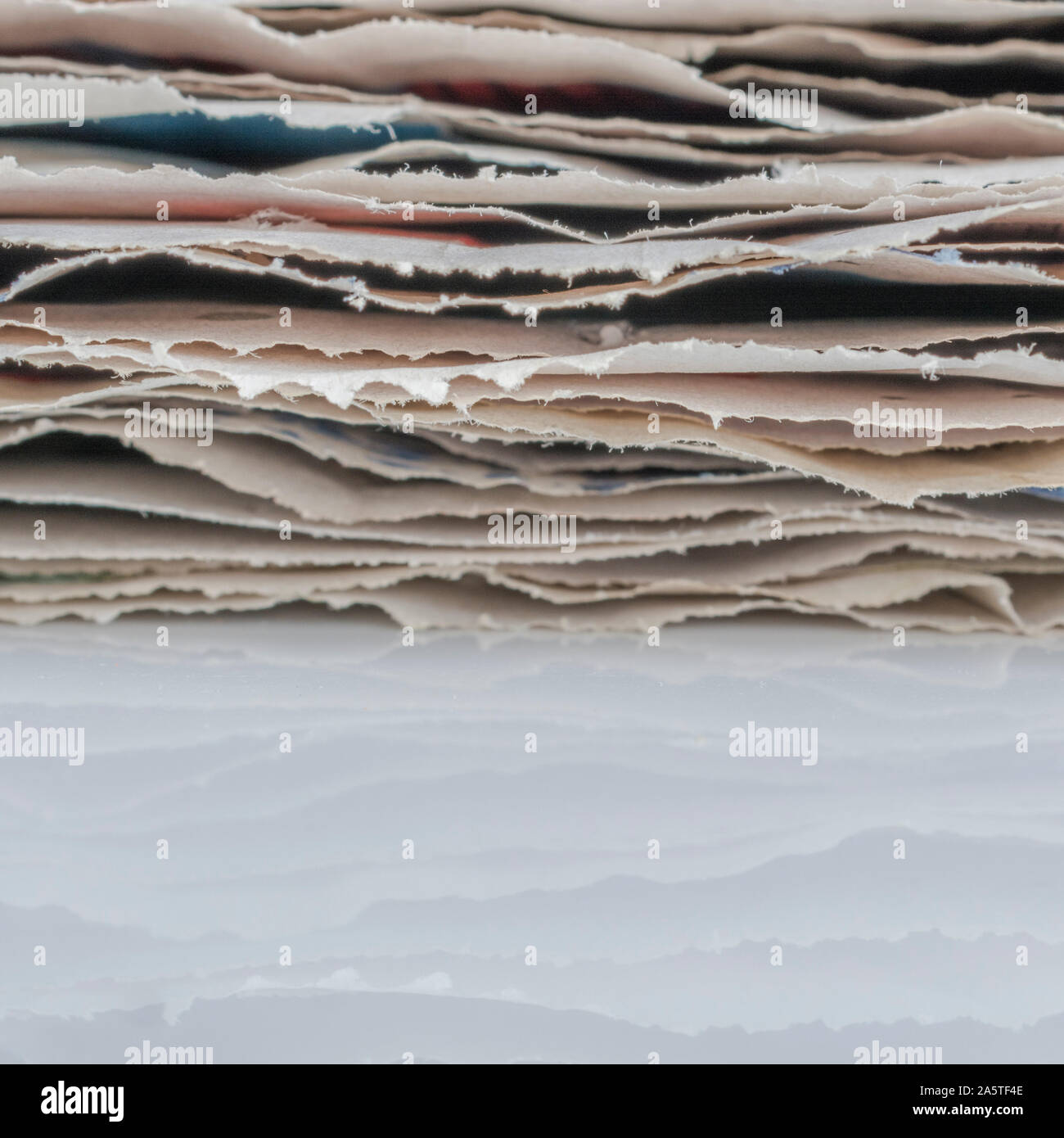 Old newspaper pages stacked. Traditional print media, front page news ...