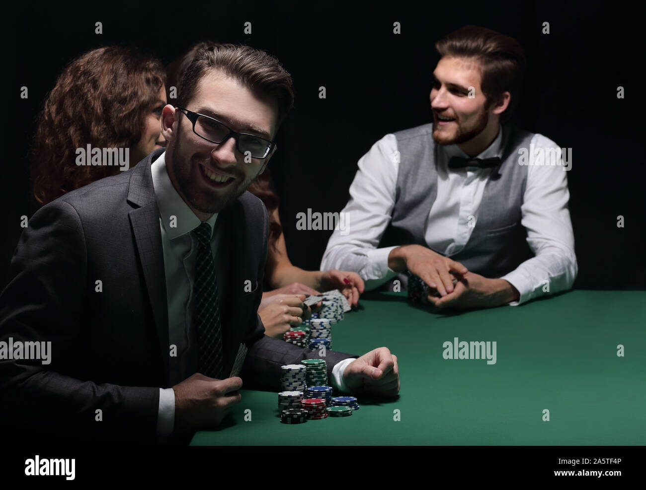 modern businessman playing poker in the night club Stock Photo - Alamy