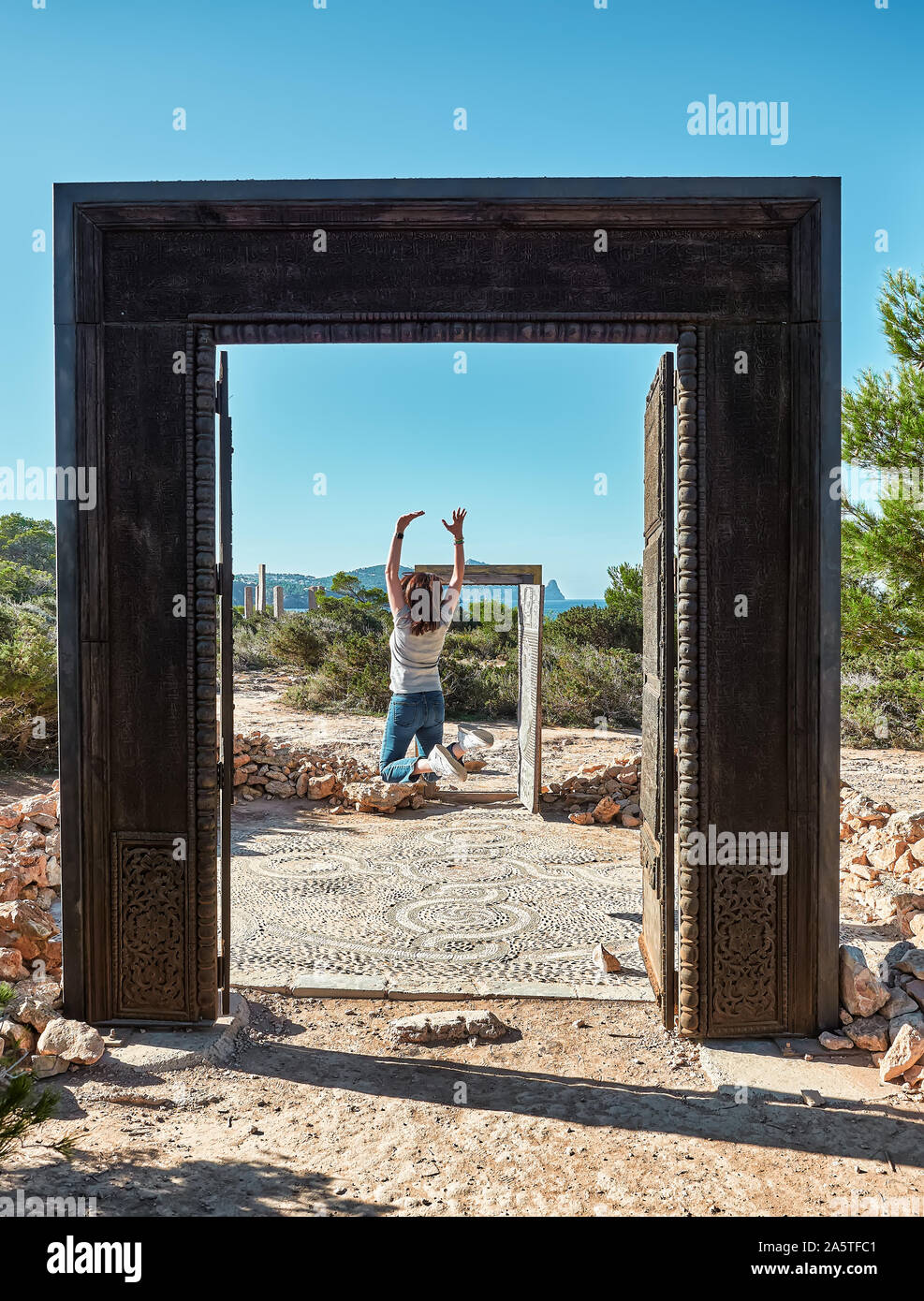 landscape and doors of Cala LLentia in Ibiza, Baleares, Spain.Woman ...