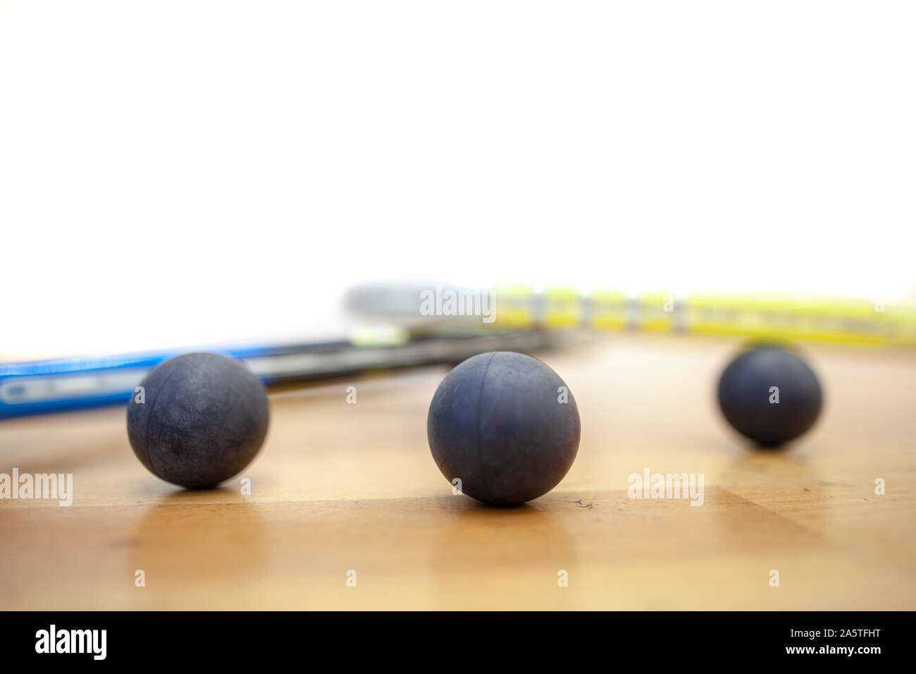 squash ball on court with squash rackets ready to play Stock Photo - Alamy