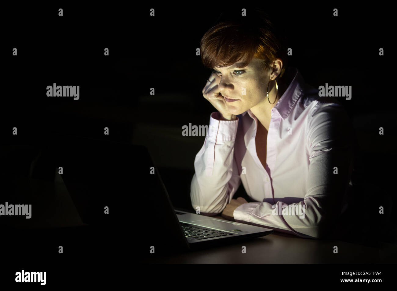 woman works with a laptop in classrooms at the university. She studies ...