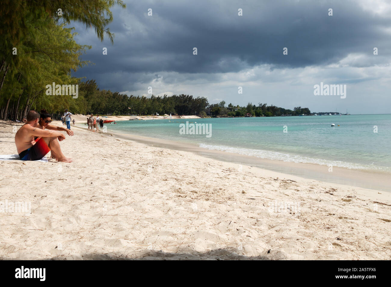 Mauritius beach; tourists sunbathing on Mont Choisy beach at the Trou ...