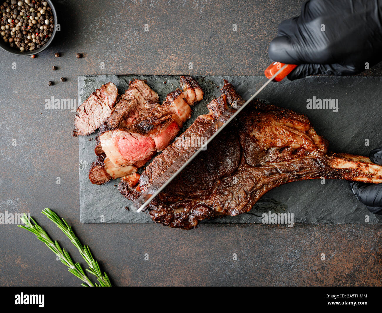 Top view of serving grilled dry-aged marble beef steak Tomahawk with ...