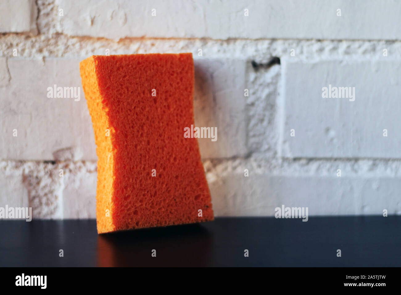 Orange sponge on a table in the sink Stock Photo - Alamy