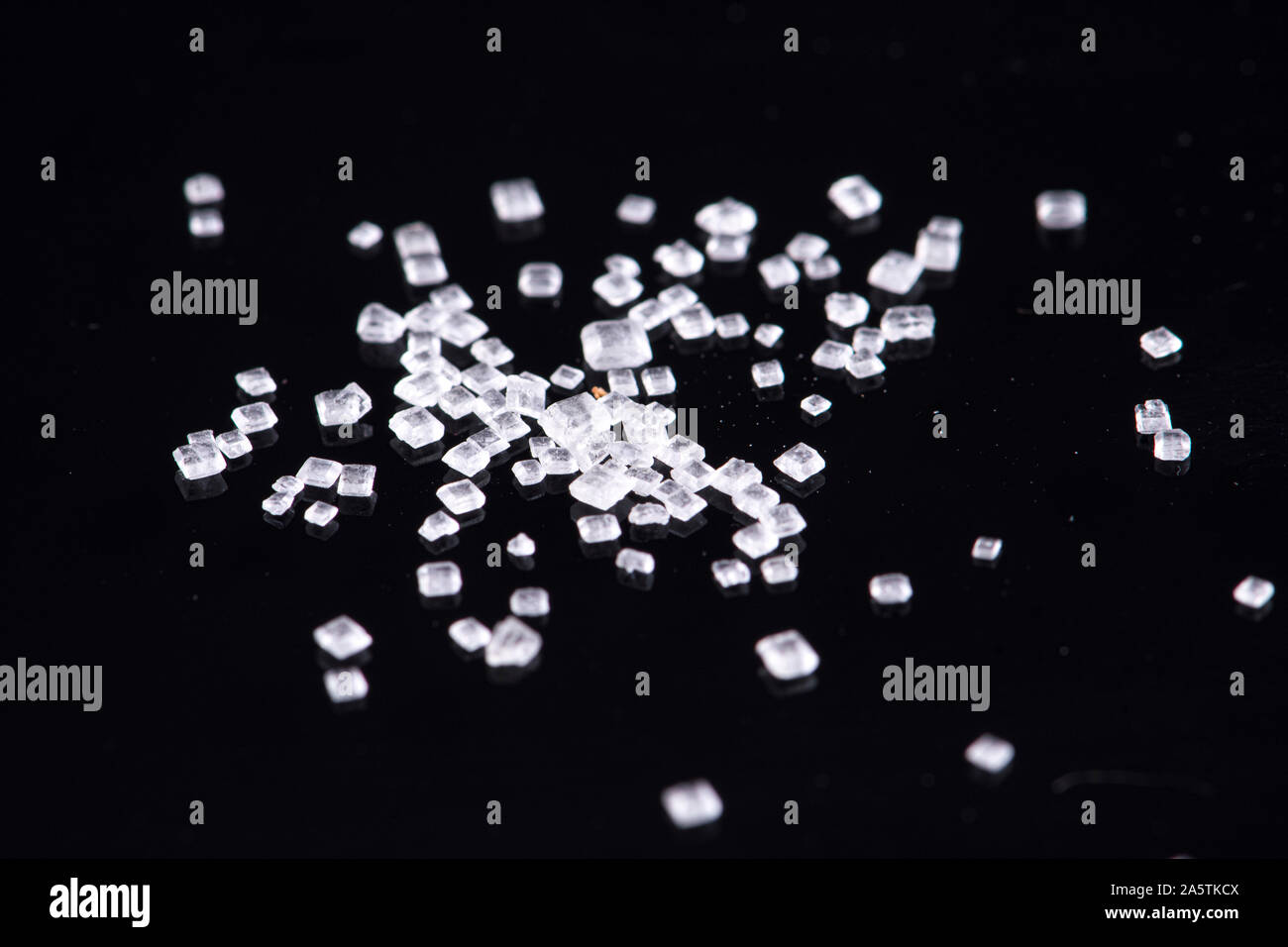 white crystals of salt and sugar on black Stock Photo - Alamy