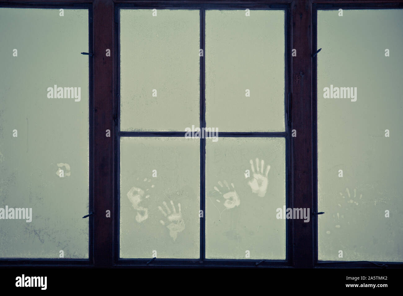 Window in the room covered with frosty mosaic in winter. Frost patterns ...