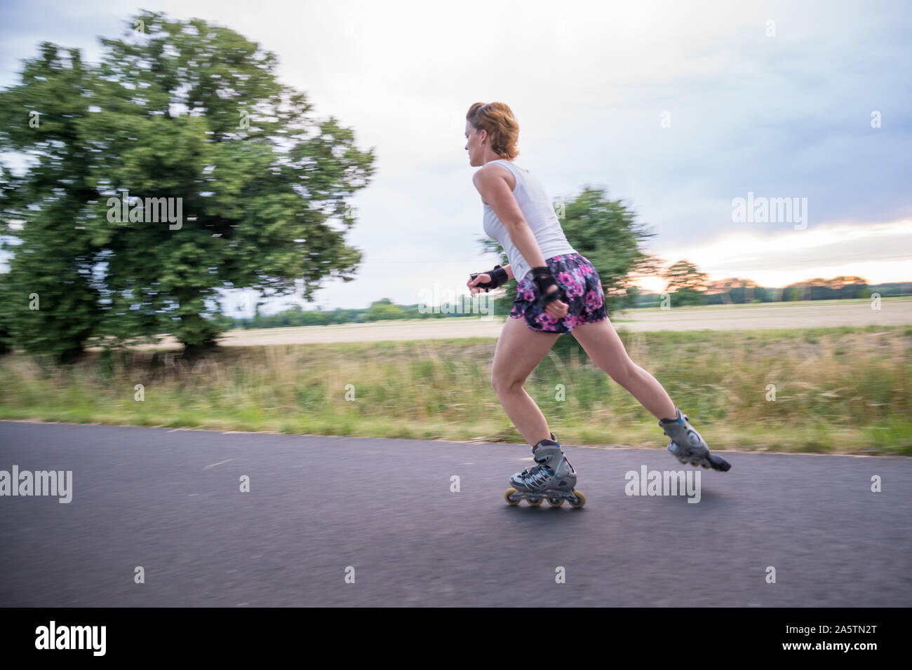 roller skates in action on the asphalt trail at freestyle races outside ...