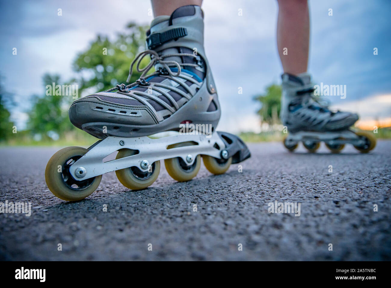 roller skates in action on the asphalt trail at freestyle races outside ...