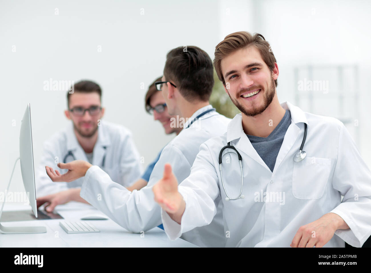 Handsome mature male doctor smiling to the camera Stock Photo - Alamy