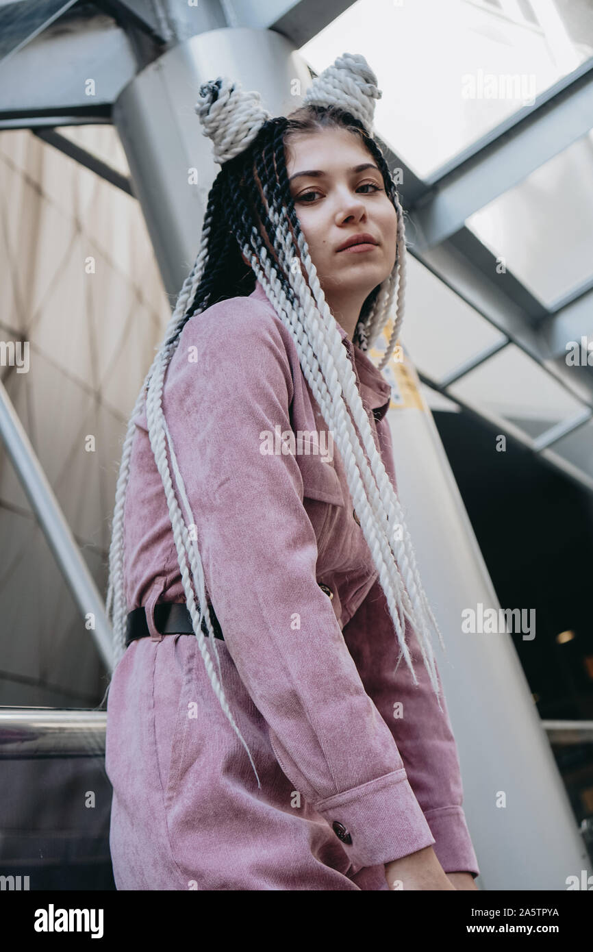 Young woman with futuristic looks. Girl with black and white dreadlocks ...