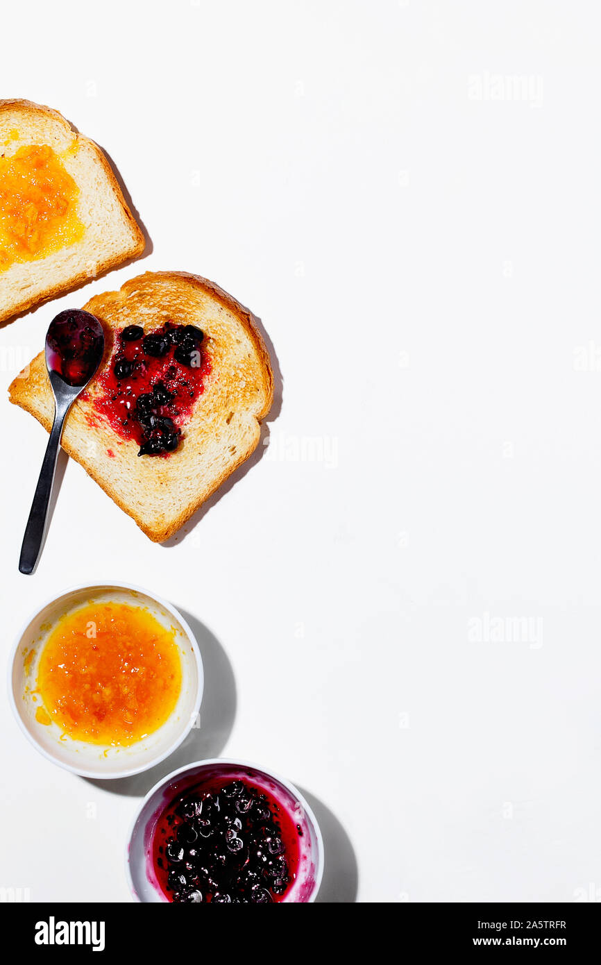 Toasted bread with tasty different jam isolated on a white background ...
