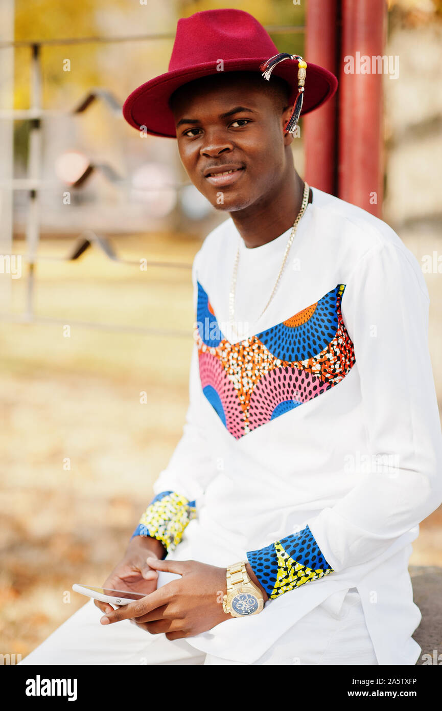 Stylish trendy afro france man in red hat and white outfit posed at ...